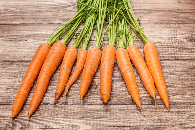 Carrot on a wooden table stock photo. Image of freshness - 40122832