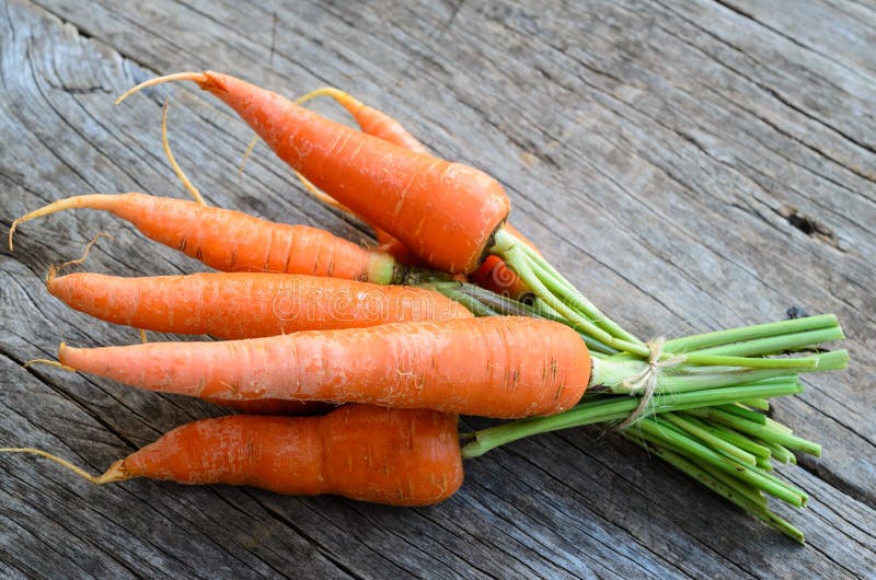 Carrot on wooden table stock image. Image of health, leaf - 48959421