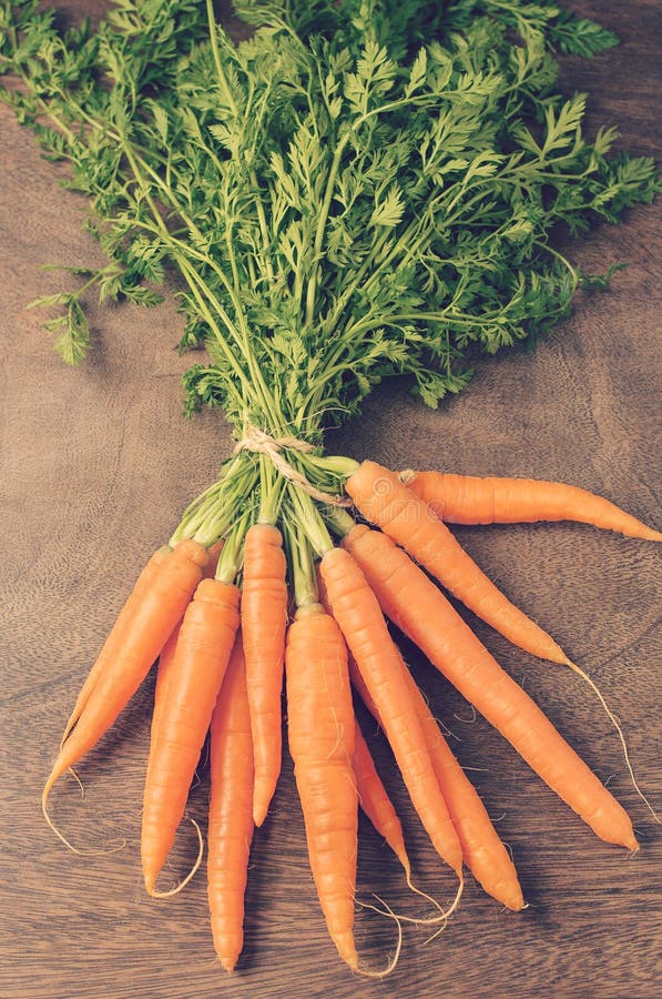 Carrots on wooden table stock image. Image of board, nourishment - 66562495