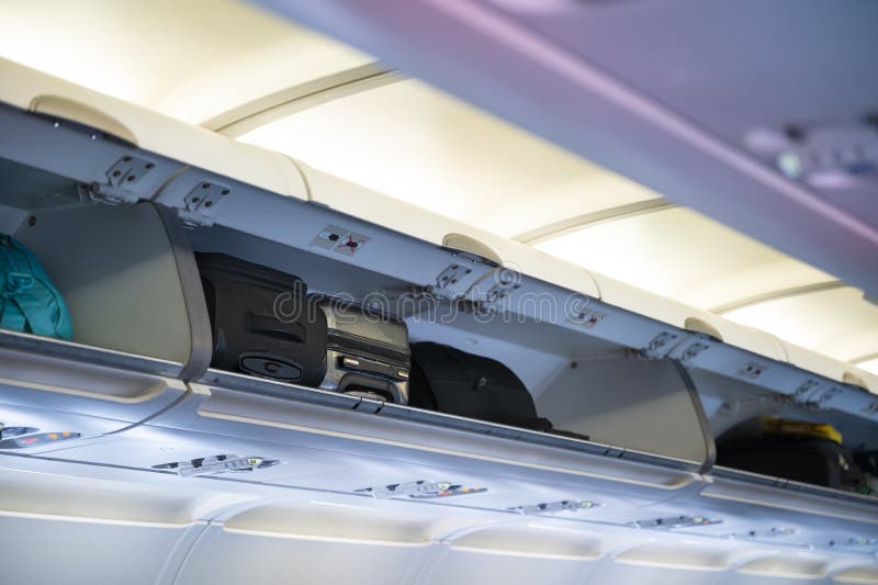 Carry-on Luggage in Overhead Shelf in Airplane Cabin Stock Photo ...