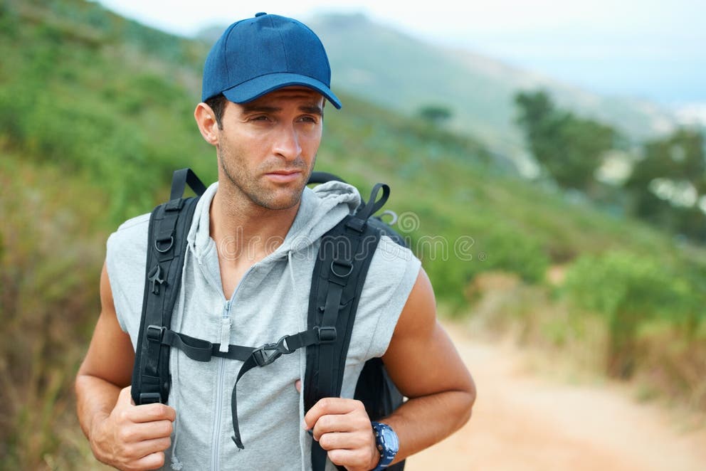 Carrying on Down the Road.... Young Hiker Wearing a Backpack Looking ...