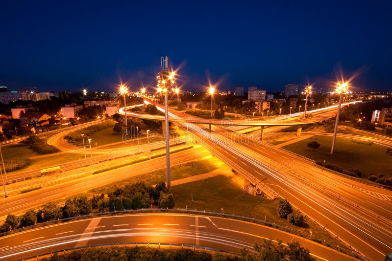 Cars Moving through Highway Intersection at Dusk Stock Image - Image of ...