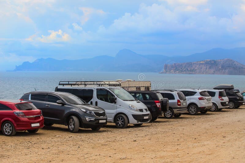 Cars on the sandy seashore stock image. Image of dirt - 218622927