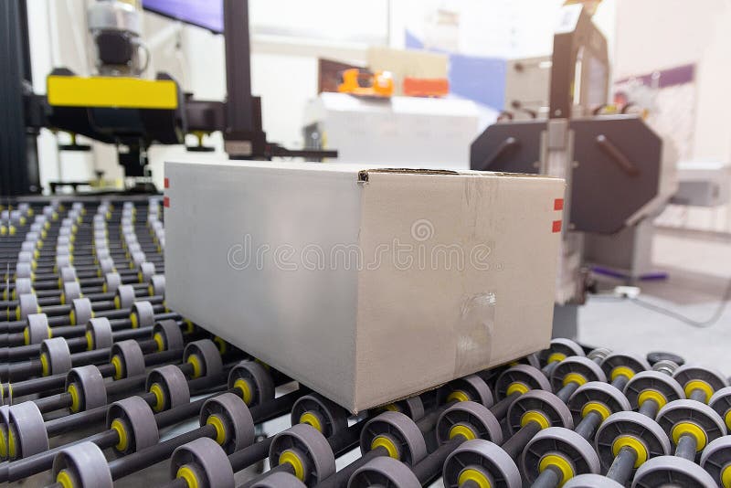 The Carton-like Packaging Moves Smoothly Along a Conveyor Belt in the ...