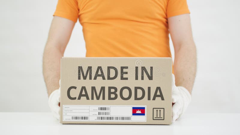 Carton with MADE in CAMBODIA Text Being Placed on the Table Stock Photo ...