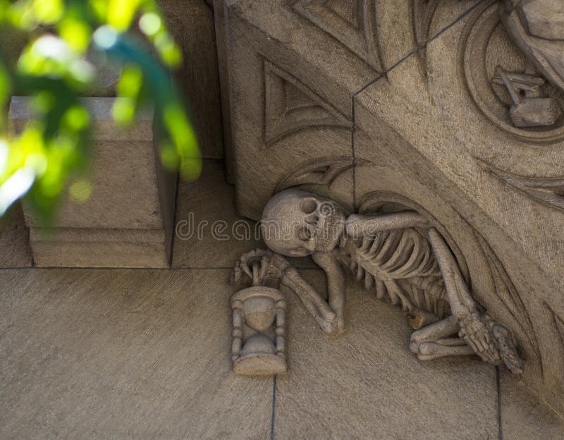 Carved Skeleton Holding a Sand Timer - the Concept of Death Stock Photo ...