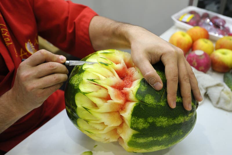 Carving. an Artist Hands Cutting Patterns on a Fresh Watermelon with a ...
