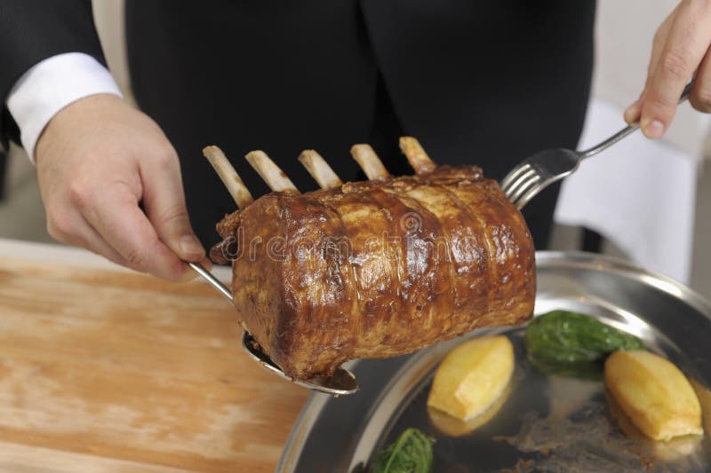 Carving a loin of lamb stock photo. Image of catering - 23707130