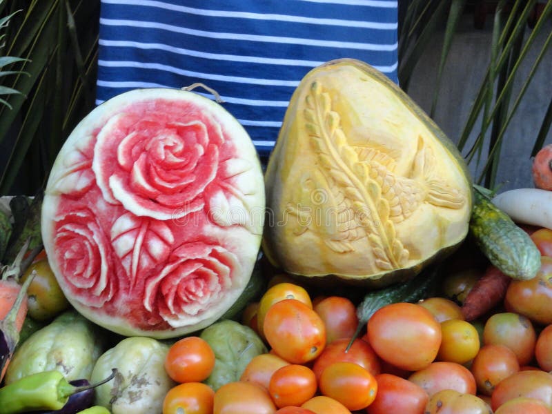 Fruit Carvings - Flower Design on Fruit and Fish Design on Squash Stock ...