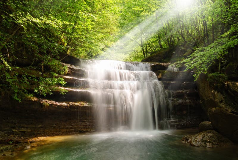 Cascade Illuminated by Sunshine Stock Image - Image of blue, plant ...