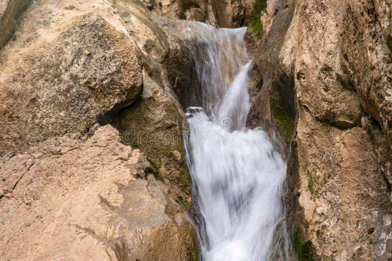 Cascades of a Small Stream Flow Down the Cliffs of Light Stone Stock ...