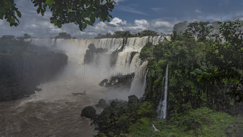 Cascades of Tropical Waterfalls Fall from the Cliffs into a Stormy ...