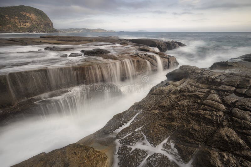 Cascades of Water Falling Down the Rocks at the Coast Stock Photo ...
