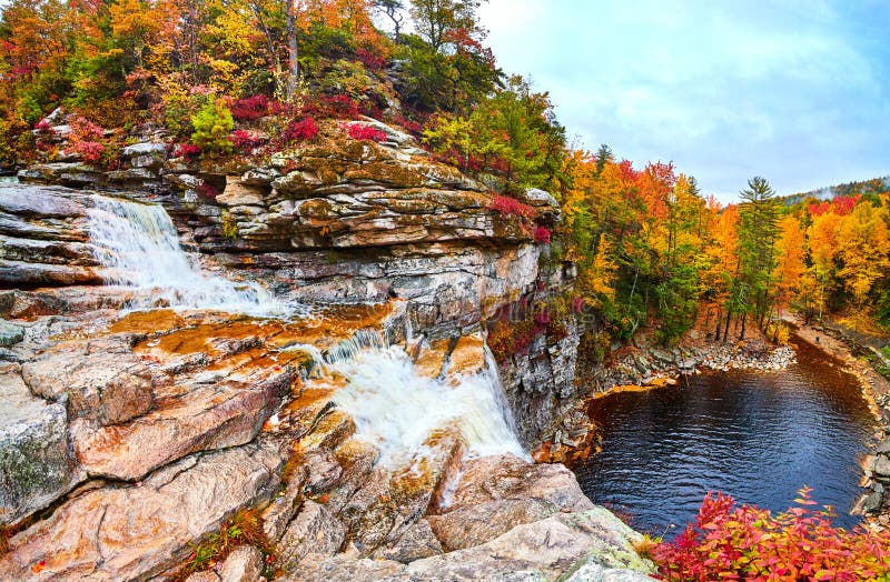 Cascading Falls Drop Off Cliff Edge into Body of Water during Colorful ...