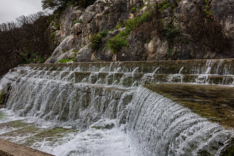 Cascading Water Flowing Over Artificial Waterfall Steps in a Rocky ...