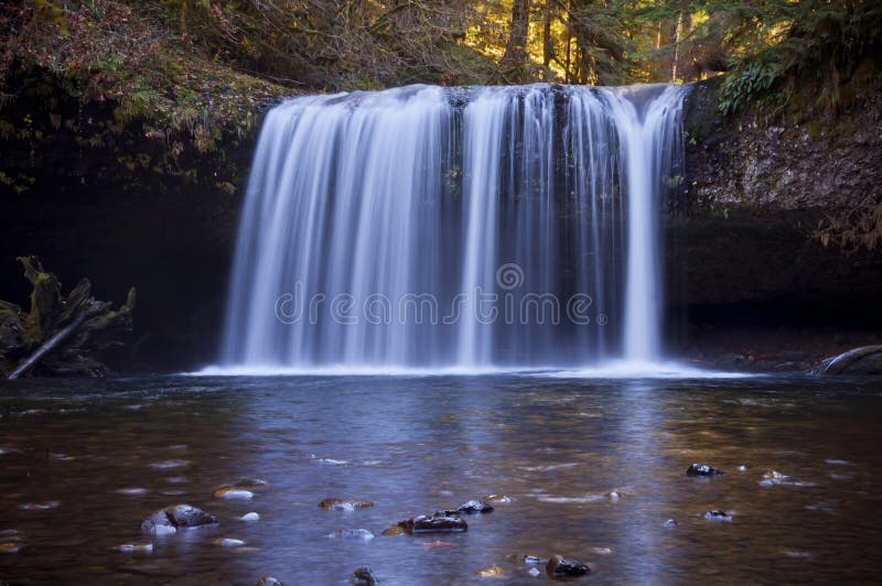 Cascading Waterfall with Light Blue Reflection in Water. Stock Image ...