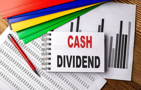 CASH DIVIDEND Text on Notebook with Folder on Chart Stock Image - Image ...