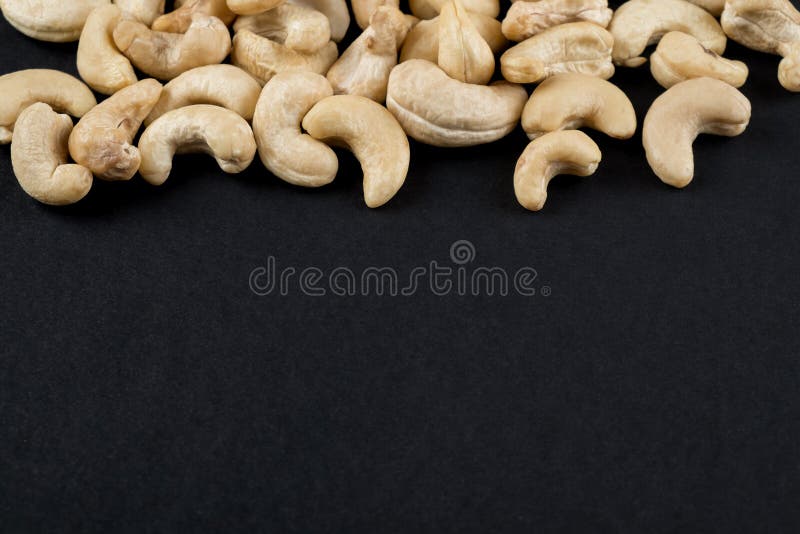 Cashew kernels on black stock photo. Image of ingredients - 107430942