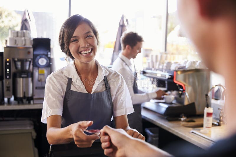 Cashier Accepts Card Payment from Customer in Delicatessen Stock Photo ...