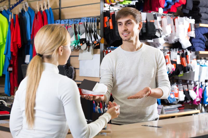 Cashier Helping Customer At The Pay Desk Stock Image - Image of hanger ...