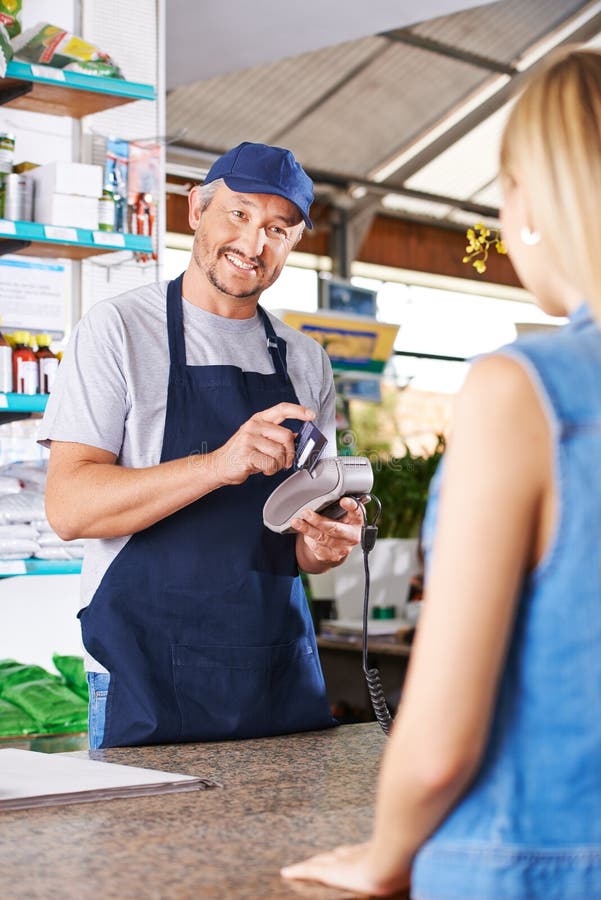 Cashier in Retail Store with Credit Card Stock Photo - Image of ...