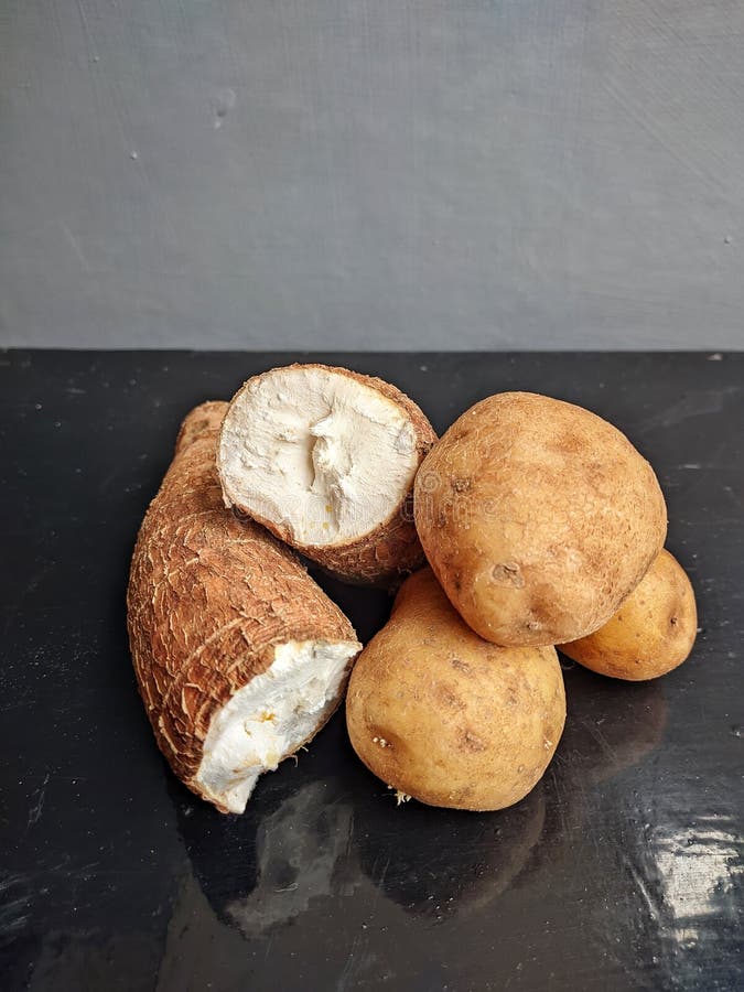 Cassava and Some Potatoes on a Black Table Stock Photo - Image of ...