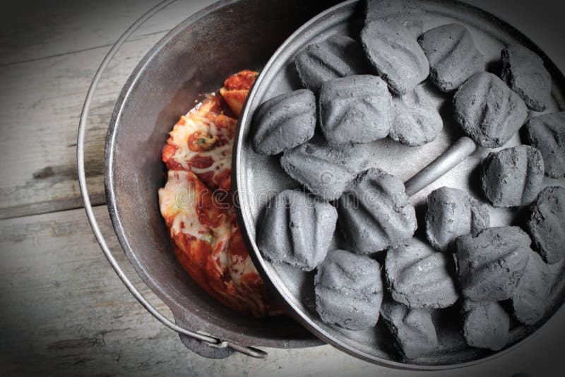 Cast Iron Dutch Oven Stuffed Shells with Charcoal Briquettes Stock ...