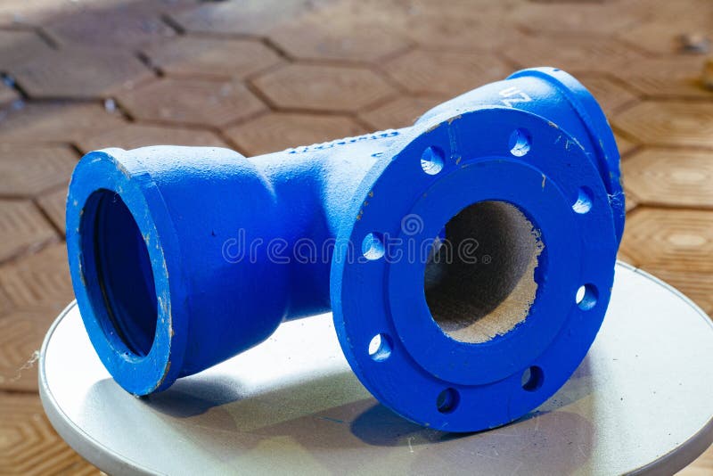 Cast Metal Pipe T Shape Connection with Flange on Gray Table Stock ...
