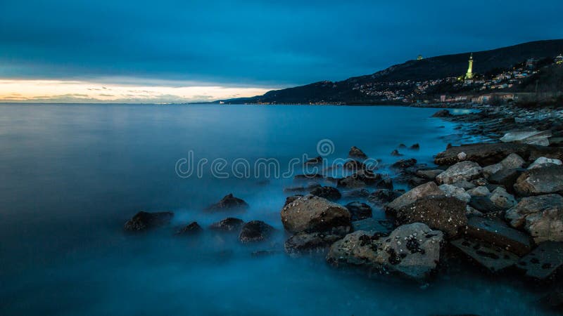 The Castle and the Lighthouse of Trieste Stock Photo - Image of clouds ...