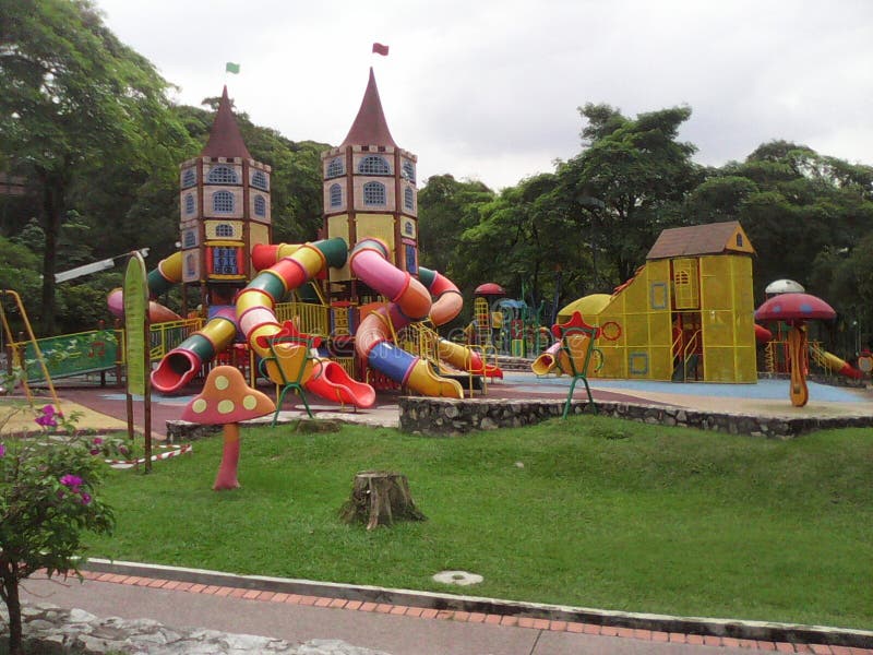 A Castle Shaped Play Structure with Colorful Slides in a Lush Park ...