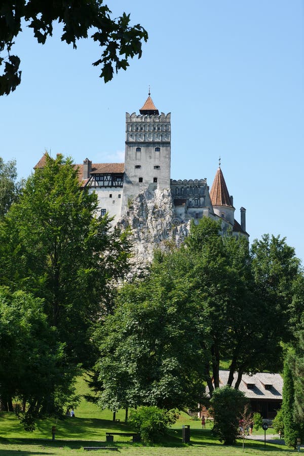 A Castle Surrounded by Trees with Bran Castle in the Background ...