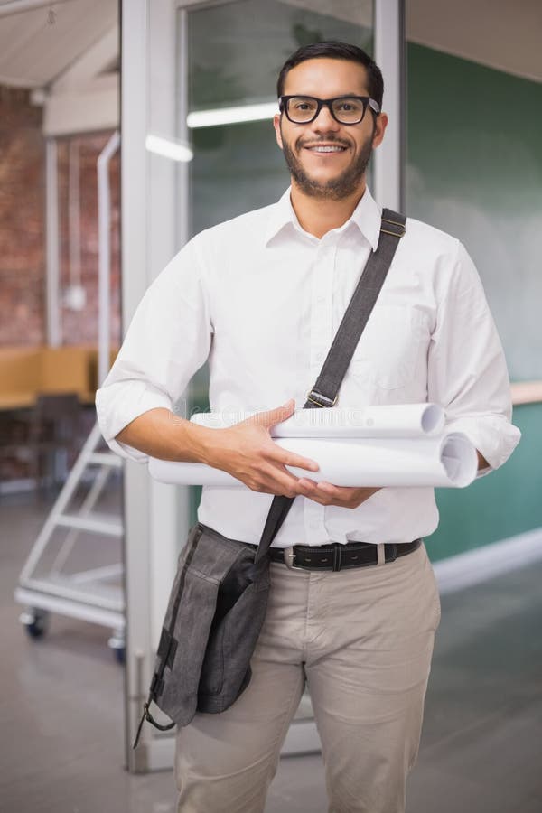 Casual Architect Smiling at Camera Holding Blueprints Stock Image ...