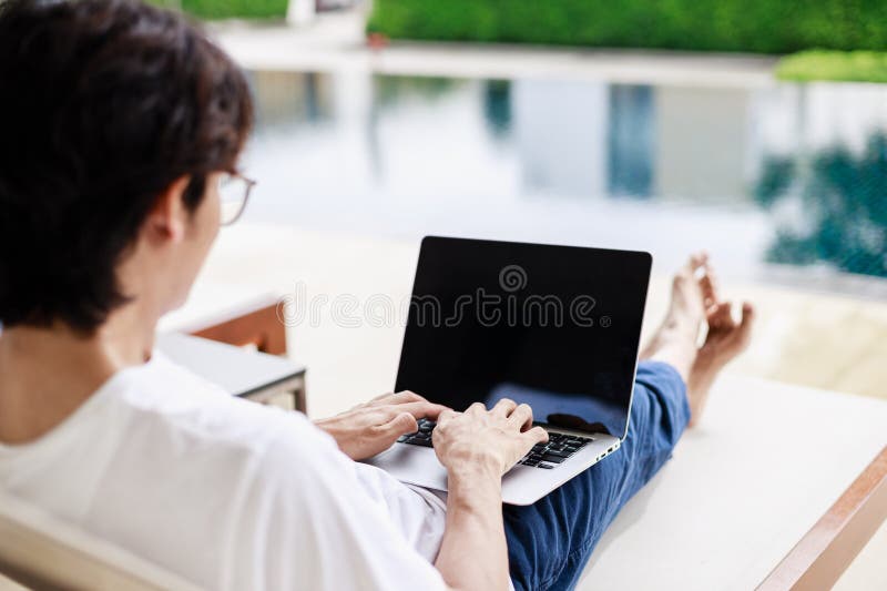 Balancing Work and Leisure, Man Works Remotely by the Pool during ...