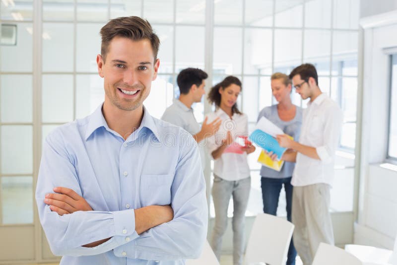 Casual Boss Smiling at Camera in Front of His Team Stock Image - Image ...
