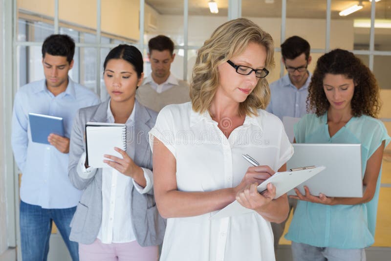 Casual Boss Standing in Front of Her Team All Taking Notes Stock Photo ...
