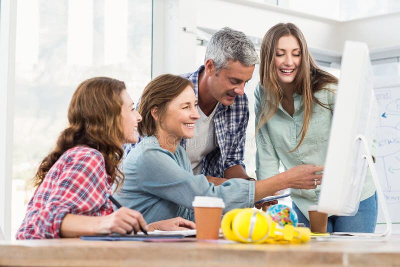 Casual Business Team Having a Meeting Using a Computer Stock Photo ...