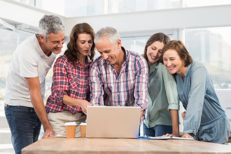 Casual Business Team Having a Meeting Using Laptop Stock Photo - Image ...