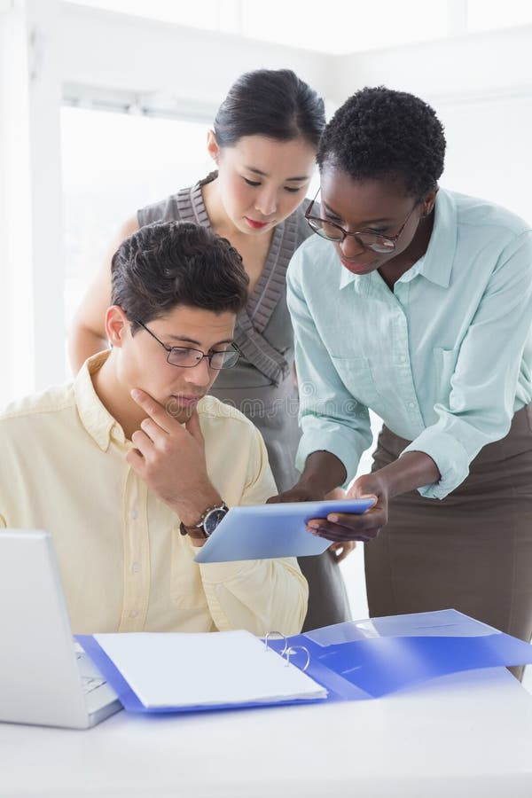 Casual Business Team Looking at Tablet Together Stock Image - Image of ...