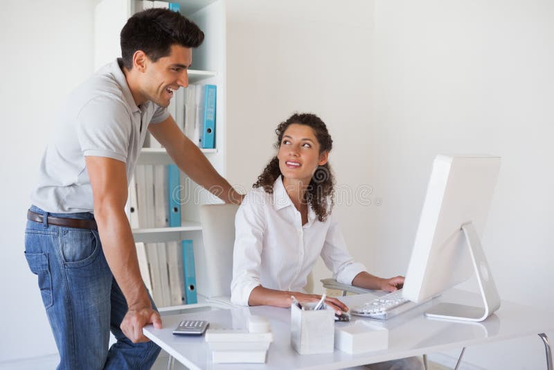 Casual Businessman Looking at Colleagues Computer Stock Image - Image ... Casual Businessman Looking at Colleagues Computer Stock Image - Image ...