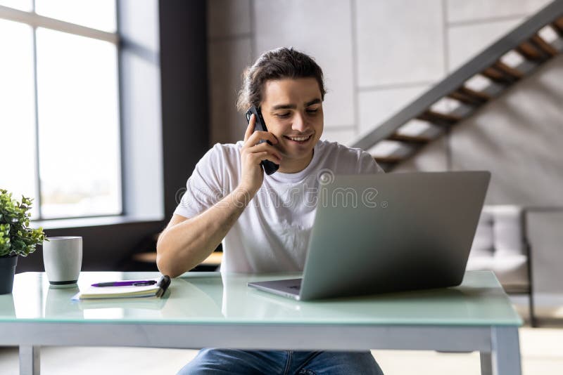 Casual Businessman Working at Office Desk, Using Mobile Phone and ...
