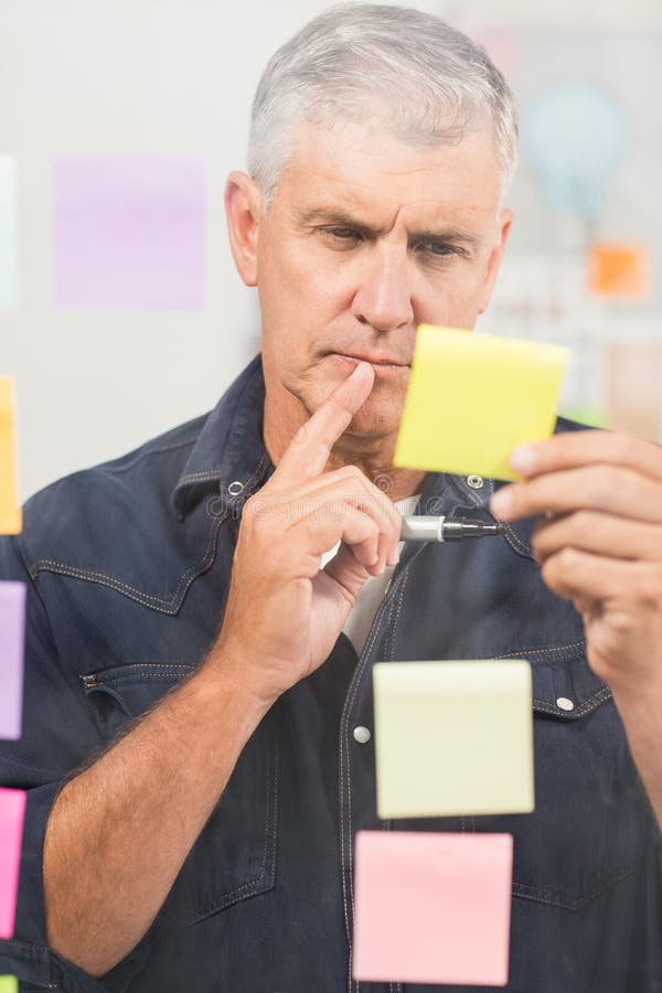 Casual Businessman Writing on Post Its Stock Image - Image of male ...