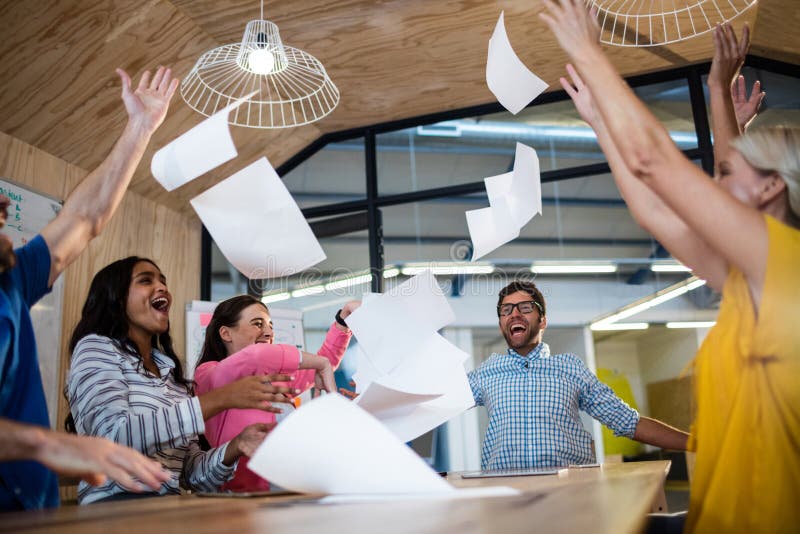Casual Colleagues Throwing Paper Stock Photo - Image of female ...