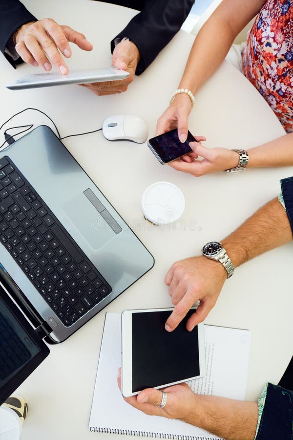 Casual Executives Using Different Electronic Objects at a Meeting ...