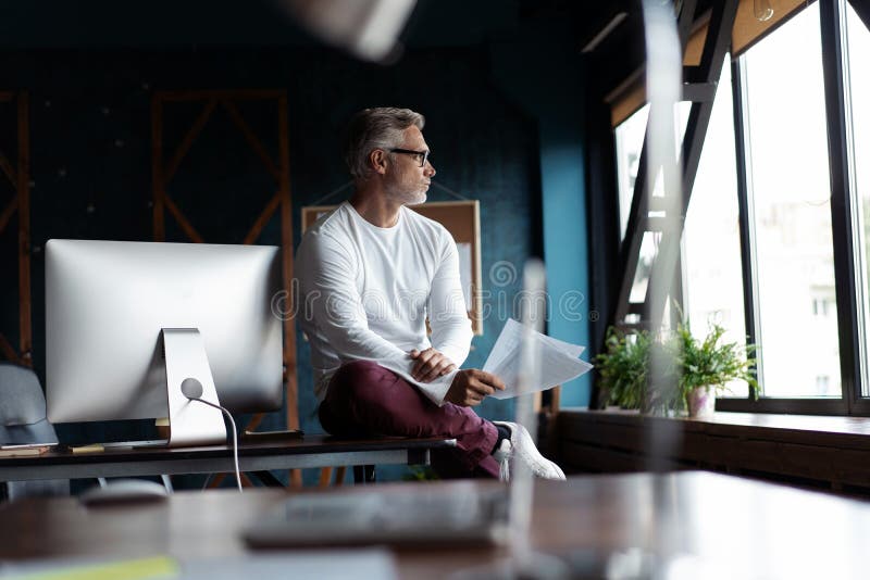 Casual Grey-haired Mature Man Reading Paper in His Office. Stock Photo ...