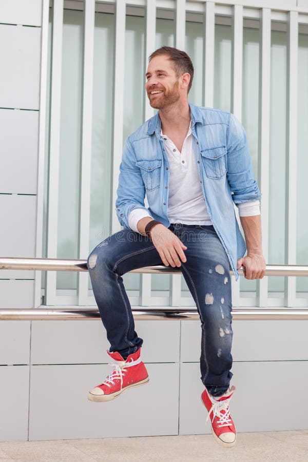 Casual Guy Sitting on a Railing in the Street Stock Image - Image of ...