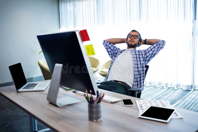 Casual Man with Hands Behind Hand Resting at Desk Stock Image - Image ...