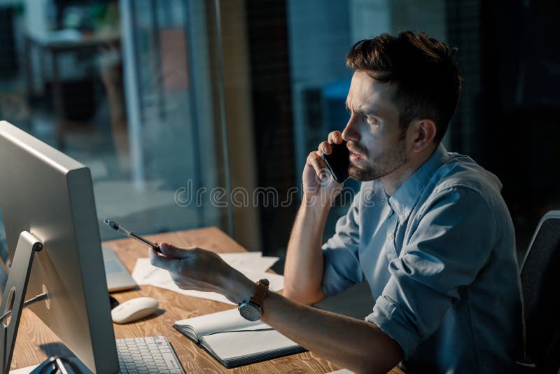 Man SpeakinÂ on Phone and Using Laptop Stock Photo - Image of ...