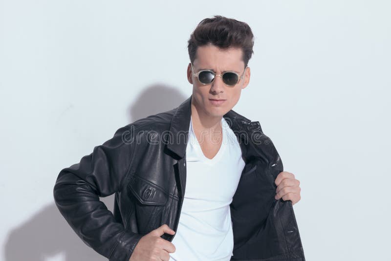 Casual Man with Macho Style is Pulling His Leather Jacket Stock Photo ...