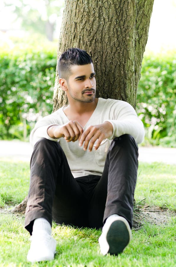Casual Man Sitting Under a Tree Stock Image - Image of masculine ...