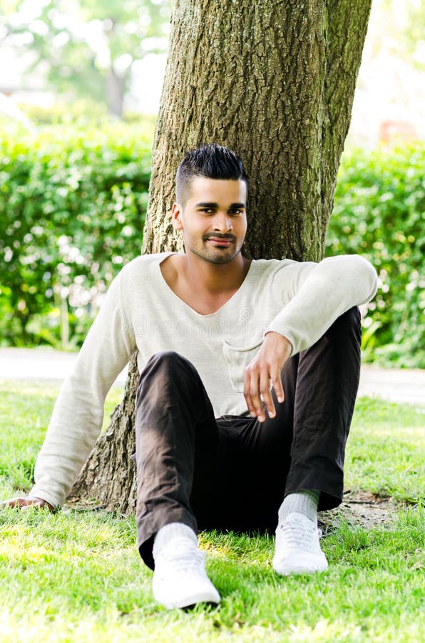 Casual Man Sitting Under a Tree Stock Photo - Image of outdoors ...